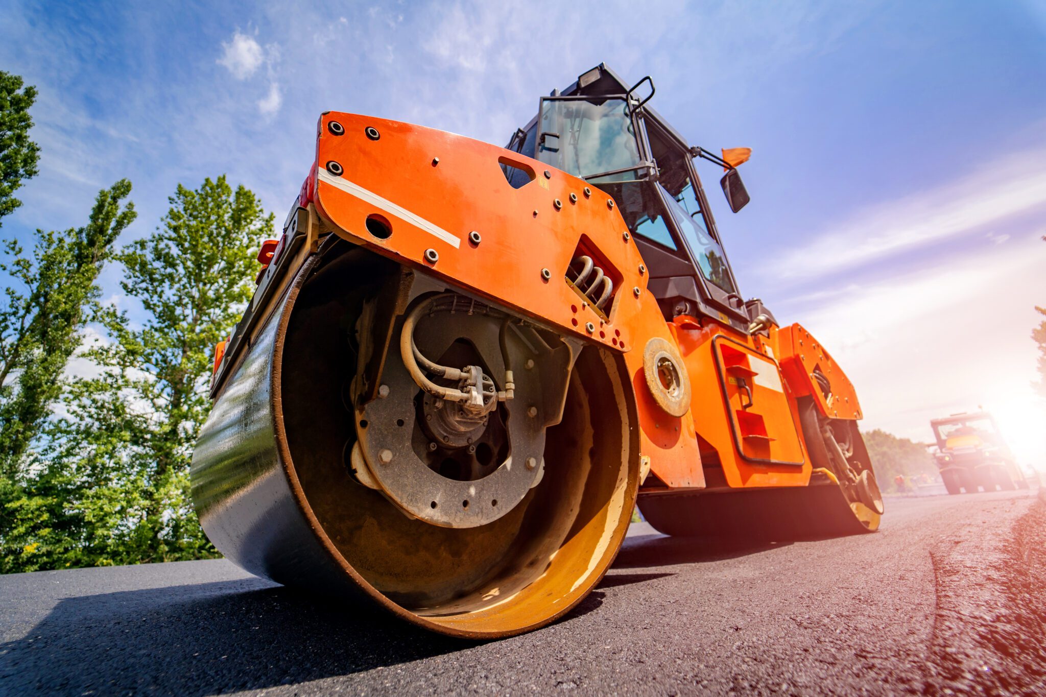 Road repair, compactor lays asphalt. Heavy special machines. Asphalt ...